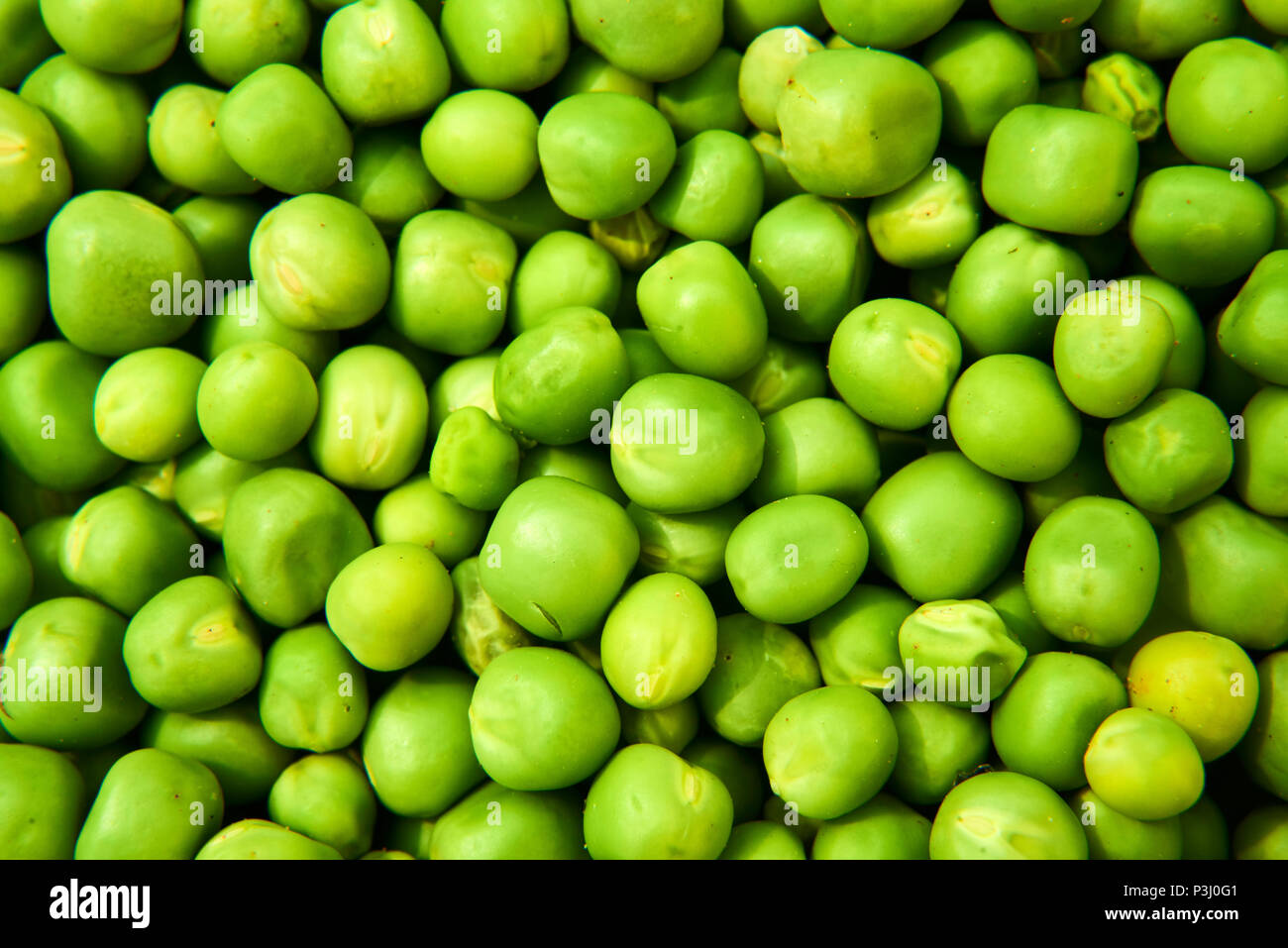 Fresh green peas background texture top view Stock Photo - Alamy