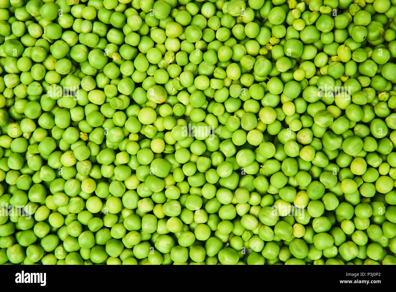 Fresh green peas background texture top view Stock Photo - Alamy