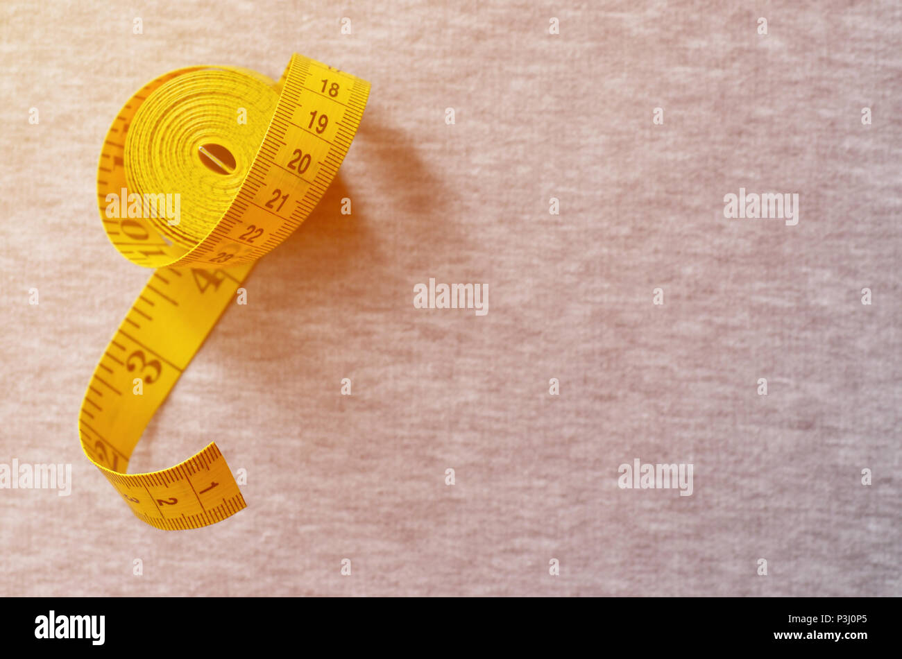 Yellow measuring tape with numerical indicators in the form of ...