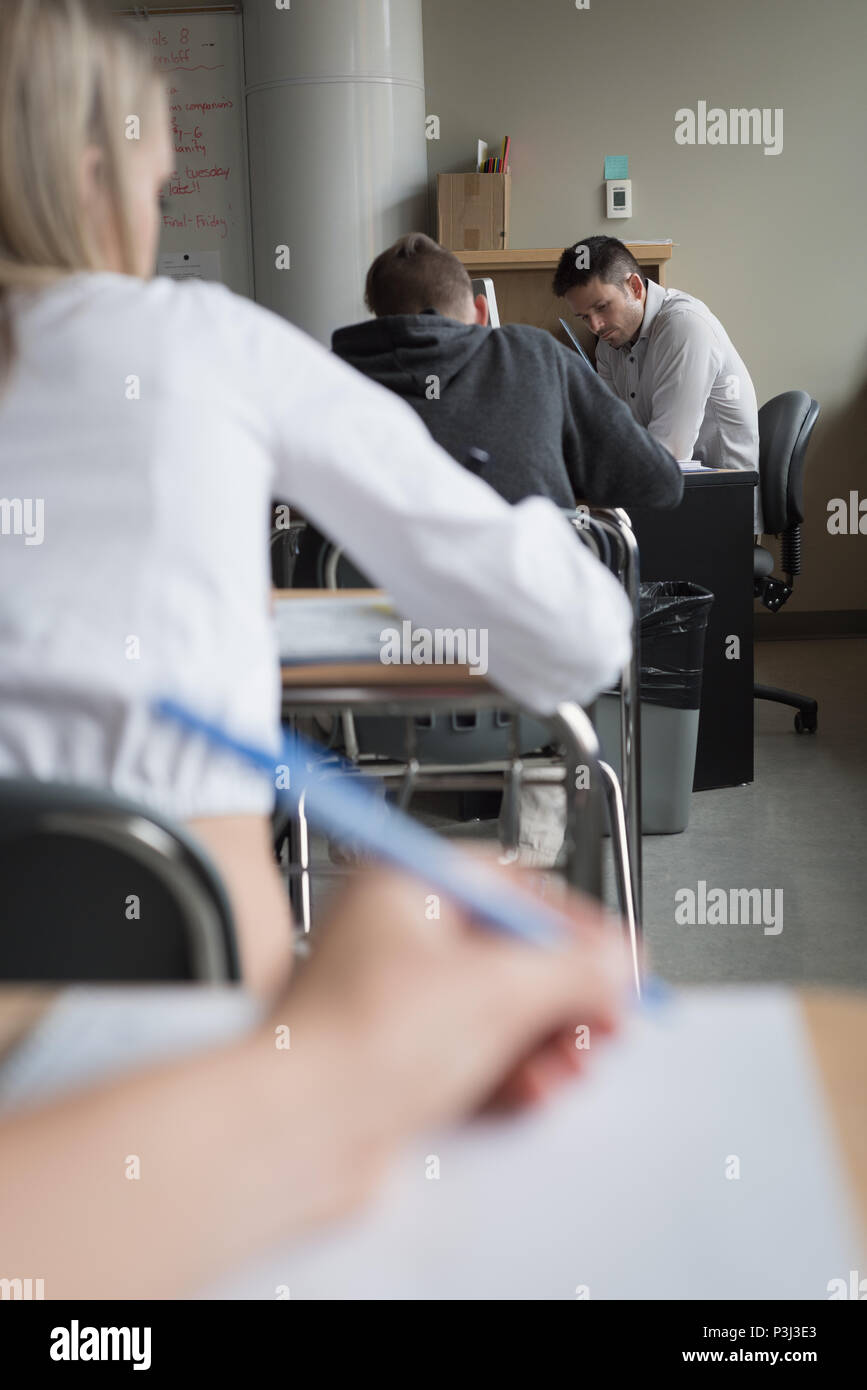 Teacher assisting university students in their studies Stock Photo - Alamy