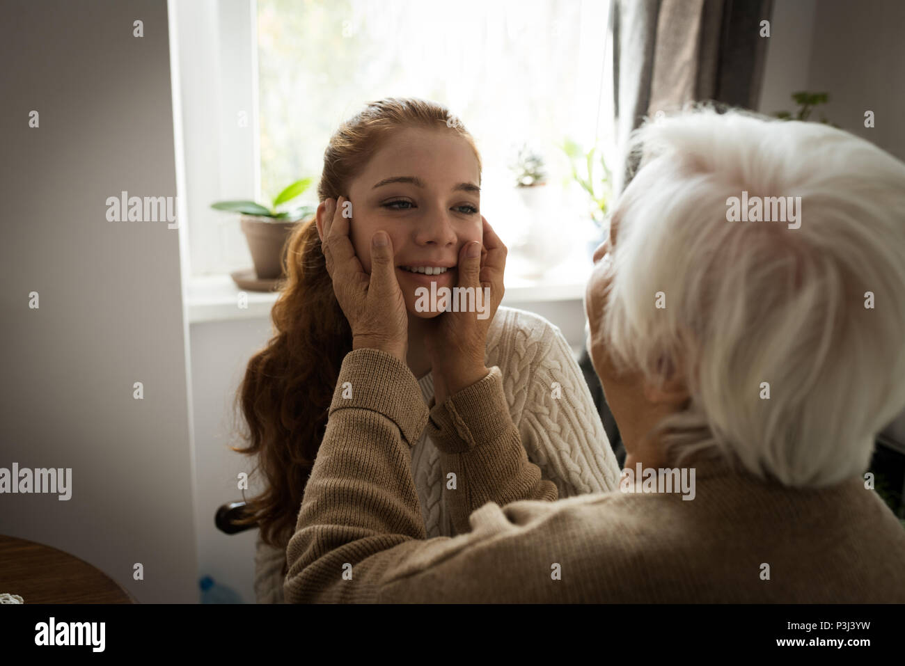 Grandmother granddaughter sitting face face hi-res stock photography ...