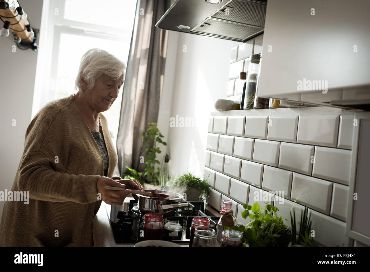 Woman cooking gas stove hi-res stock photography and images - Alamy
