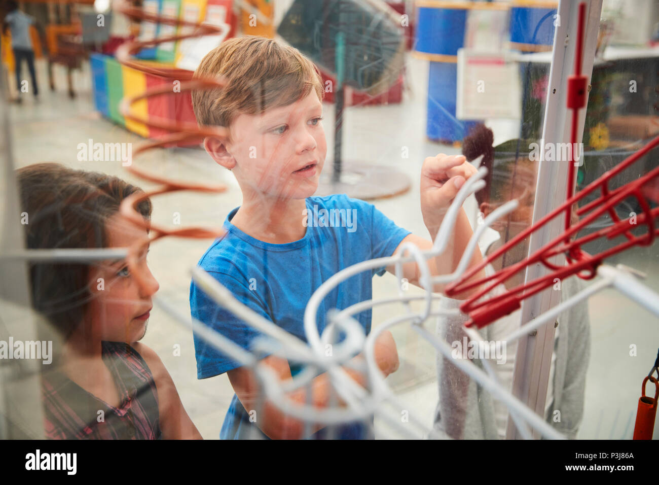 Kids looking through glass at a science exhibit, close up Stock Photo ...