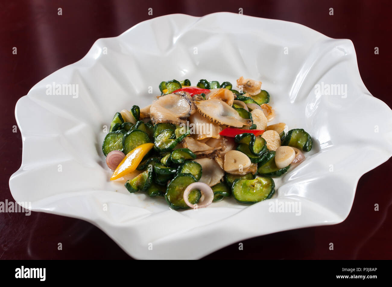 Fried abalone slices with cucumber Stock Photo - Alamy