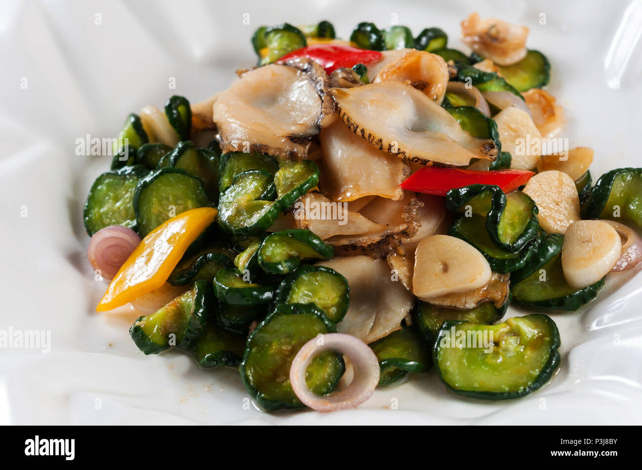 Fried abalone slices with cucumber Stock Photo - Alamy
