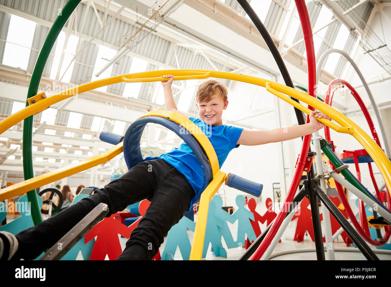 Young white boy having fun using a human gyroscope Stock Photo - Alamy