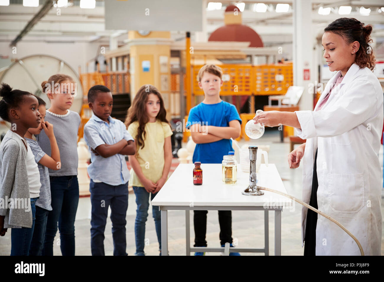 Kids watching lab technician carry out a science experiment Stock Photo ...