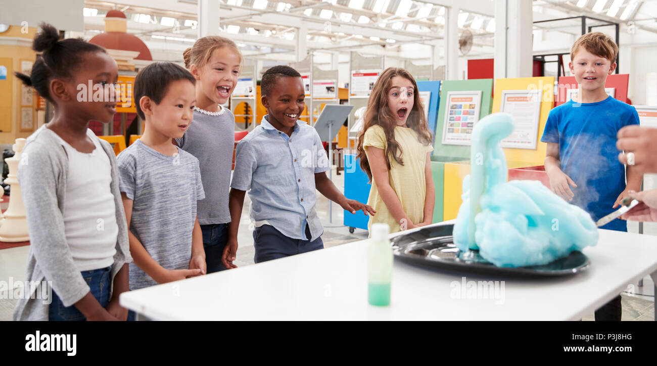 Kids having fun watching an experiment at a science centre Stock Photo ...