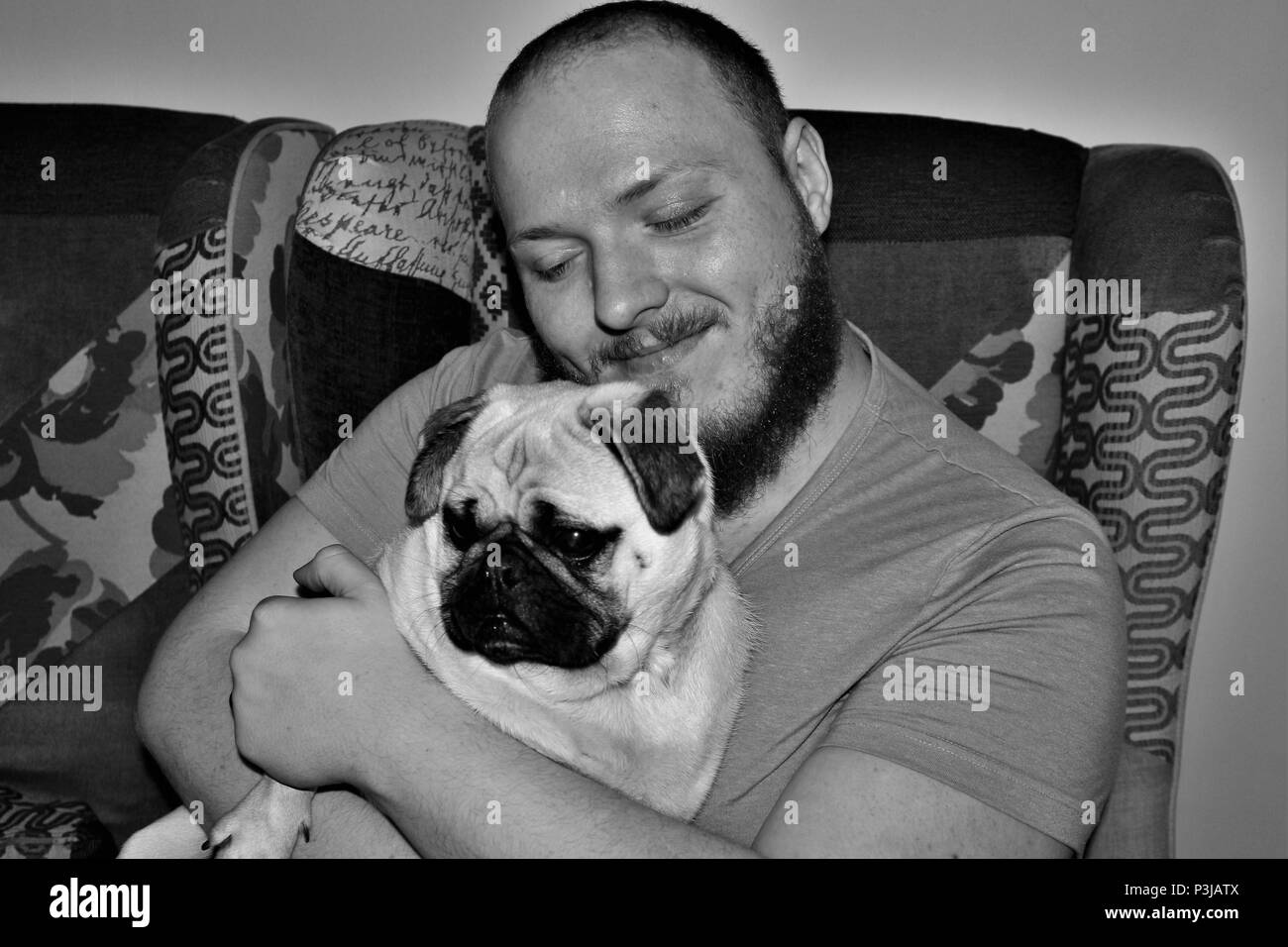 Cuddling dog man hi-res stock photography and images - Alamy