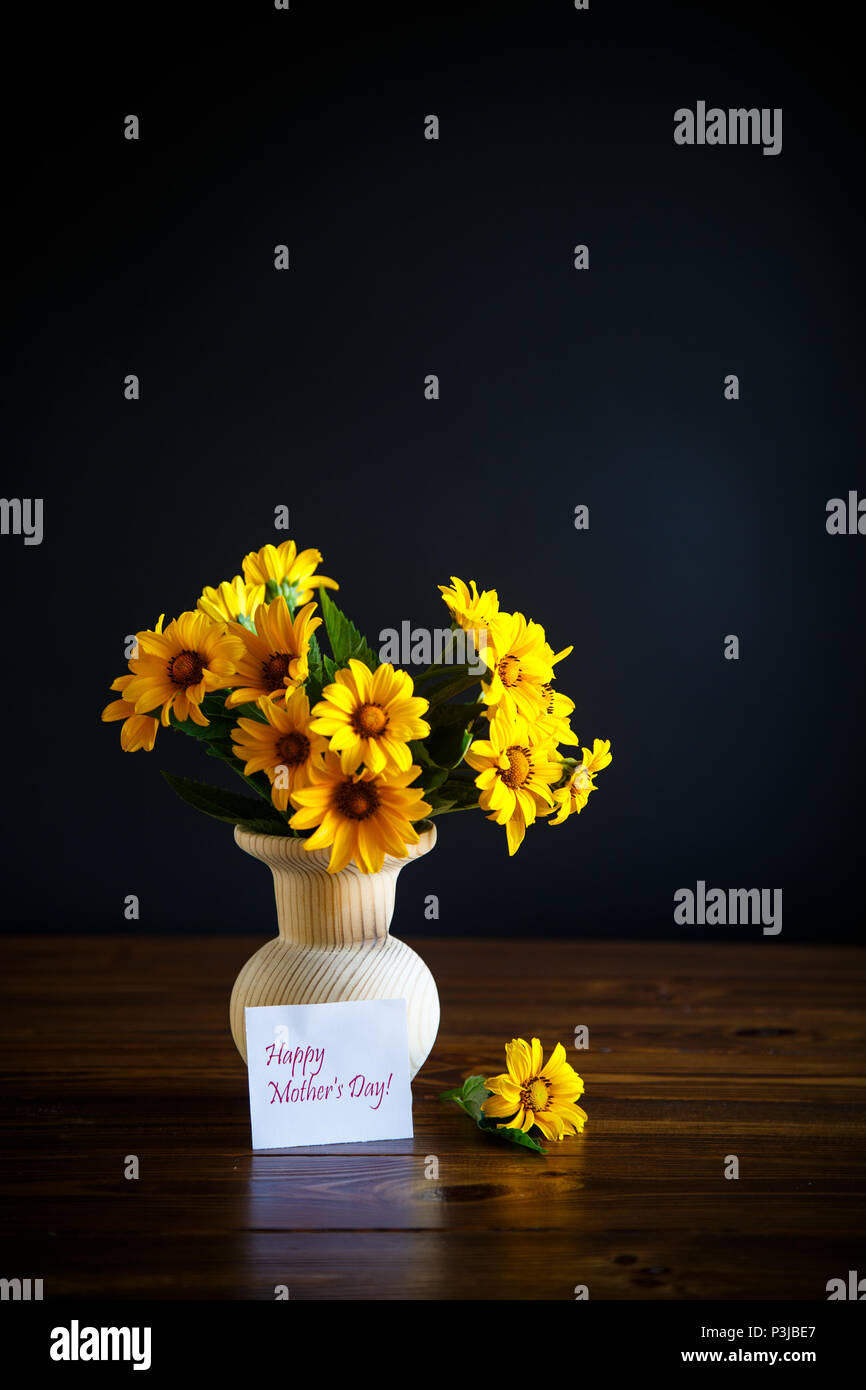bouquet of yellow big daisies on a black background Stock Photo - Alamy