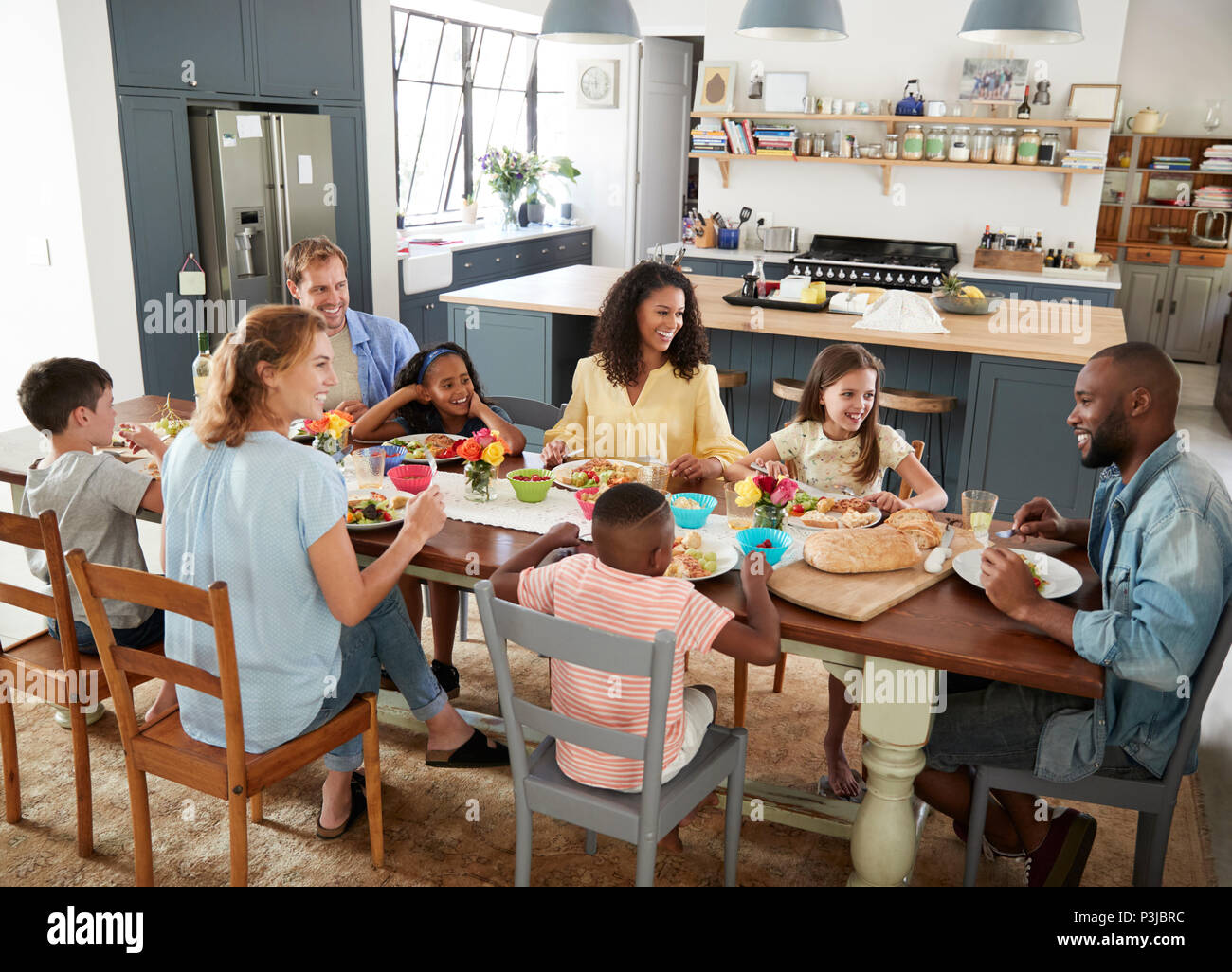 Two families having lunch together at home, elevated view Stock Photo ...