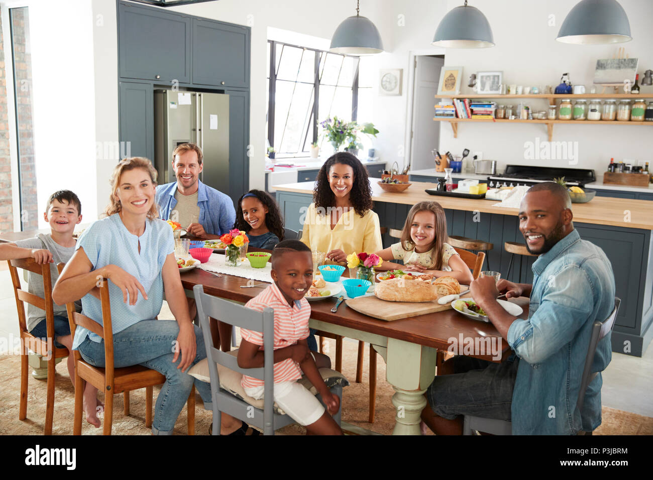 Family kids sitting around table hi-res stock photography and images ...