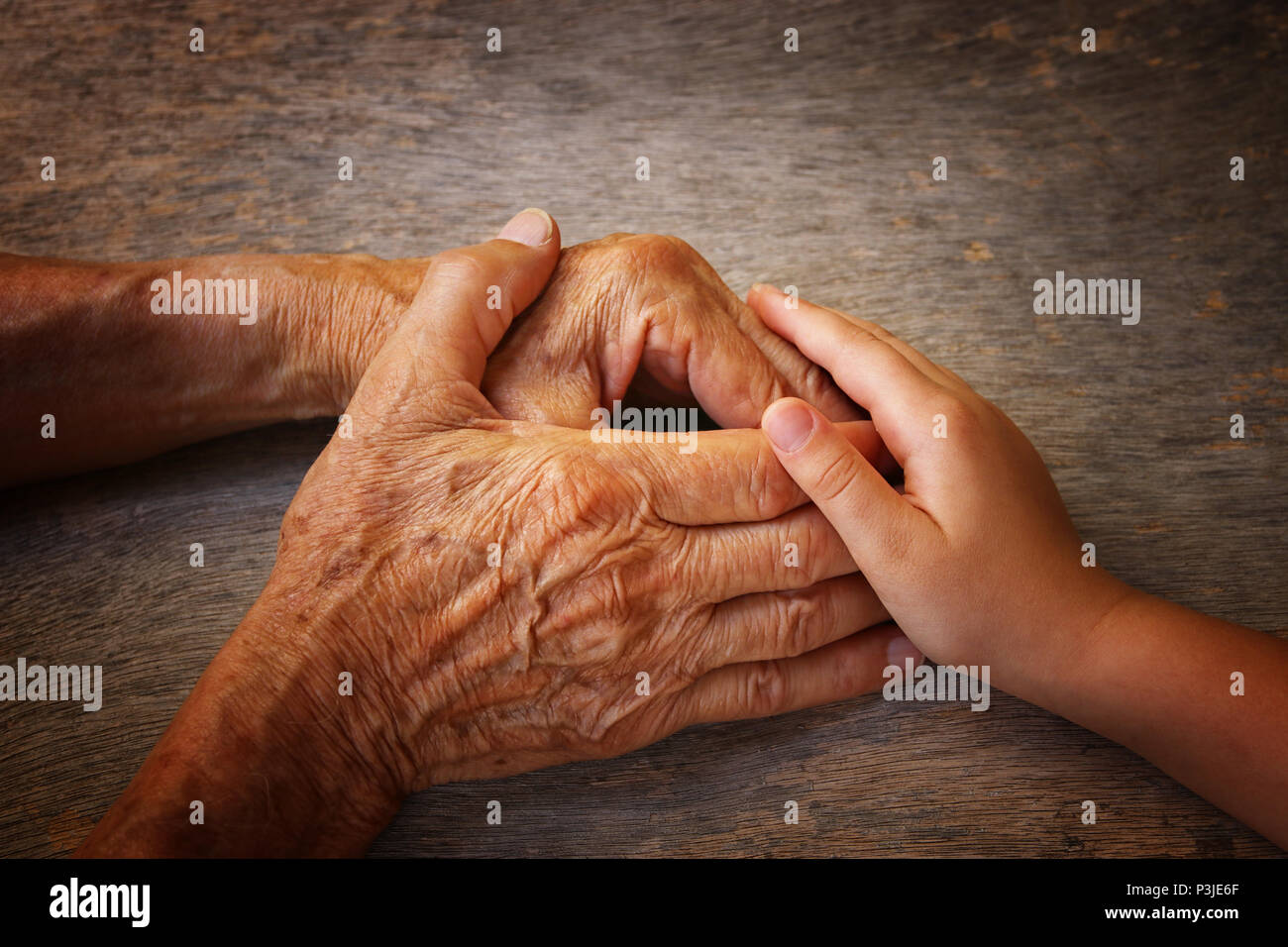 image of old man and a kid holding hands together Stock Photo - Alamy