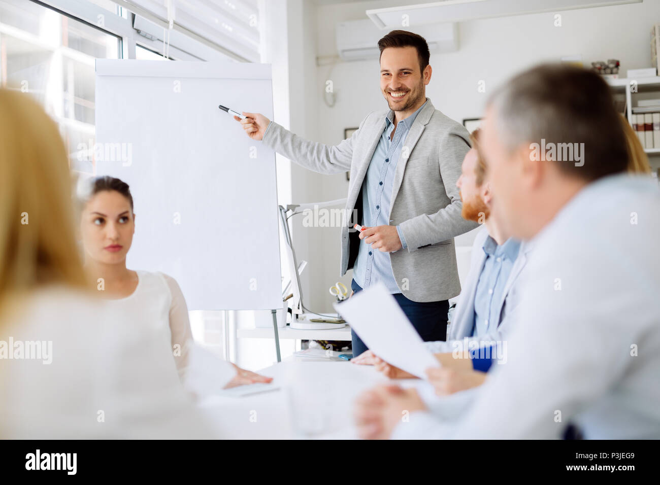 Group of business people at presentation in the office Stock Photo - Alamy