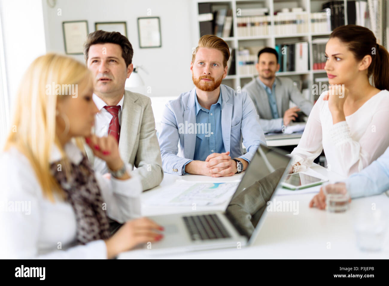 Business partners sitting table hi-res stock photography and images - Alamy