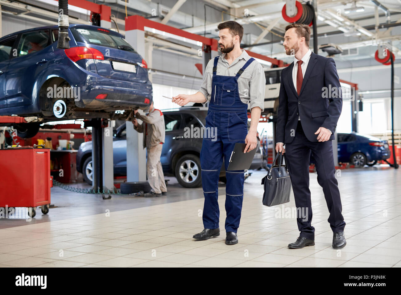Worker Giving Tour of Car Factory Stock Photo - Alamy