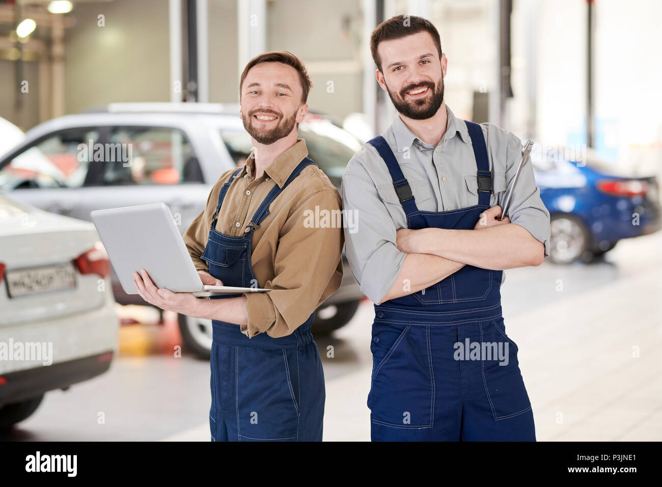 Two Workers in Car Service Stock Photo - Alamy