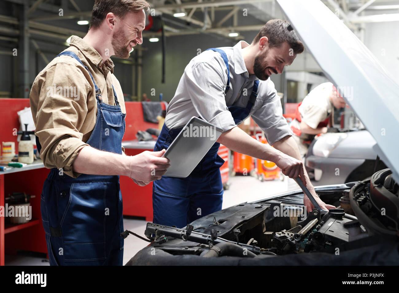 Workers Checking Car in Service Stock Photo - Alamy