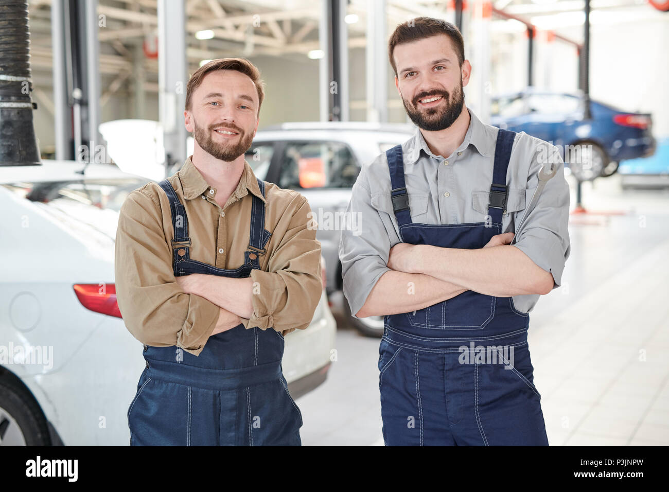 Two Workers Posing in Car Service Stock Photo - Alamy