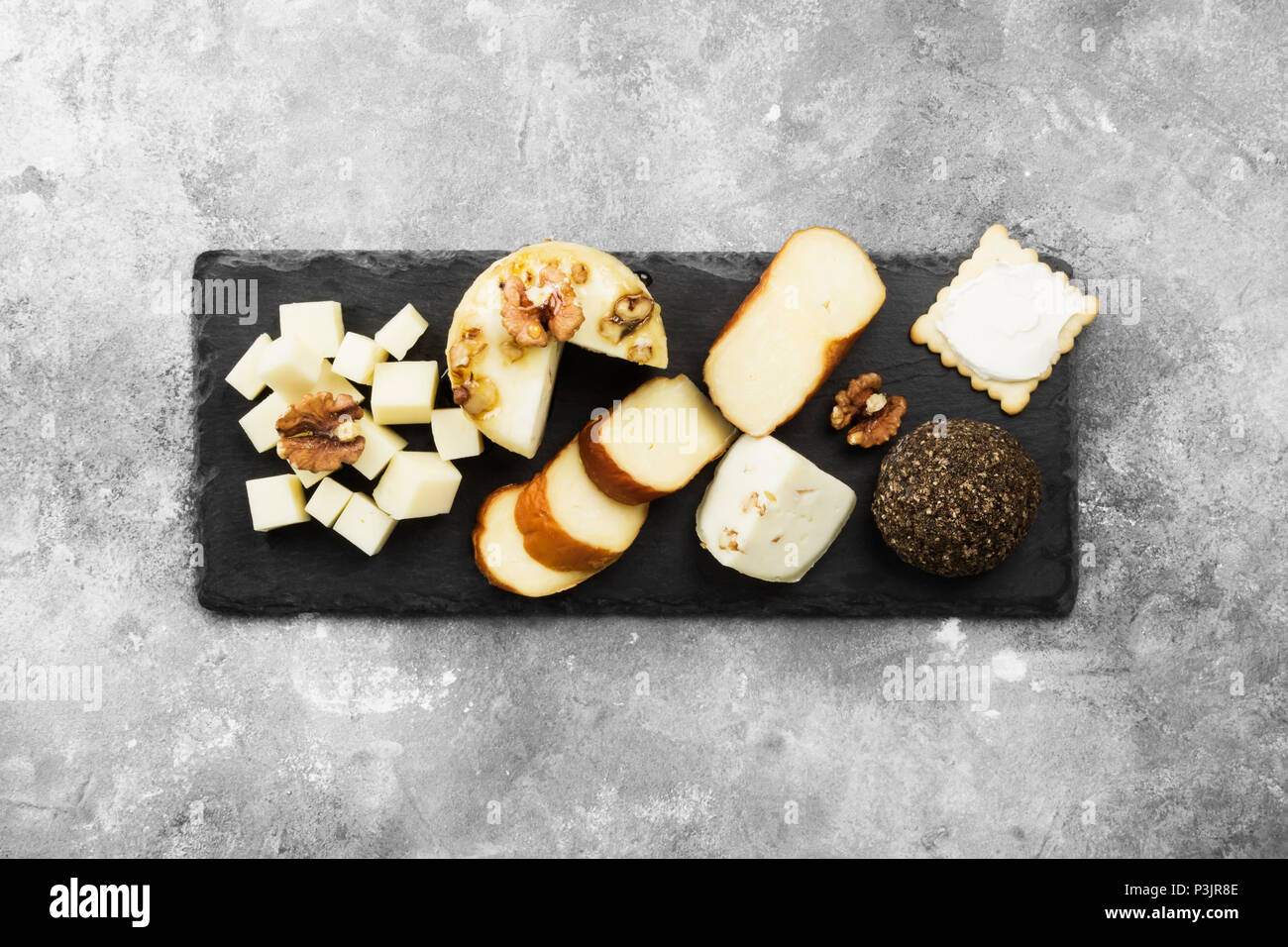 Various types of cheese on a gray background. Top view. Food background ...