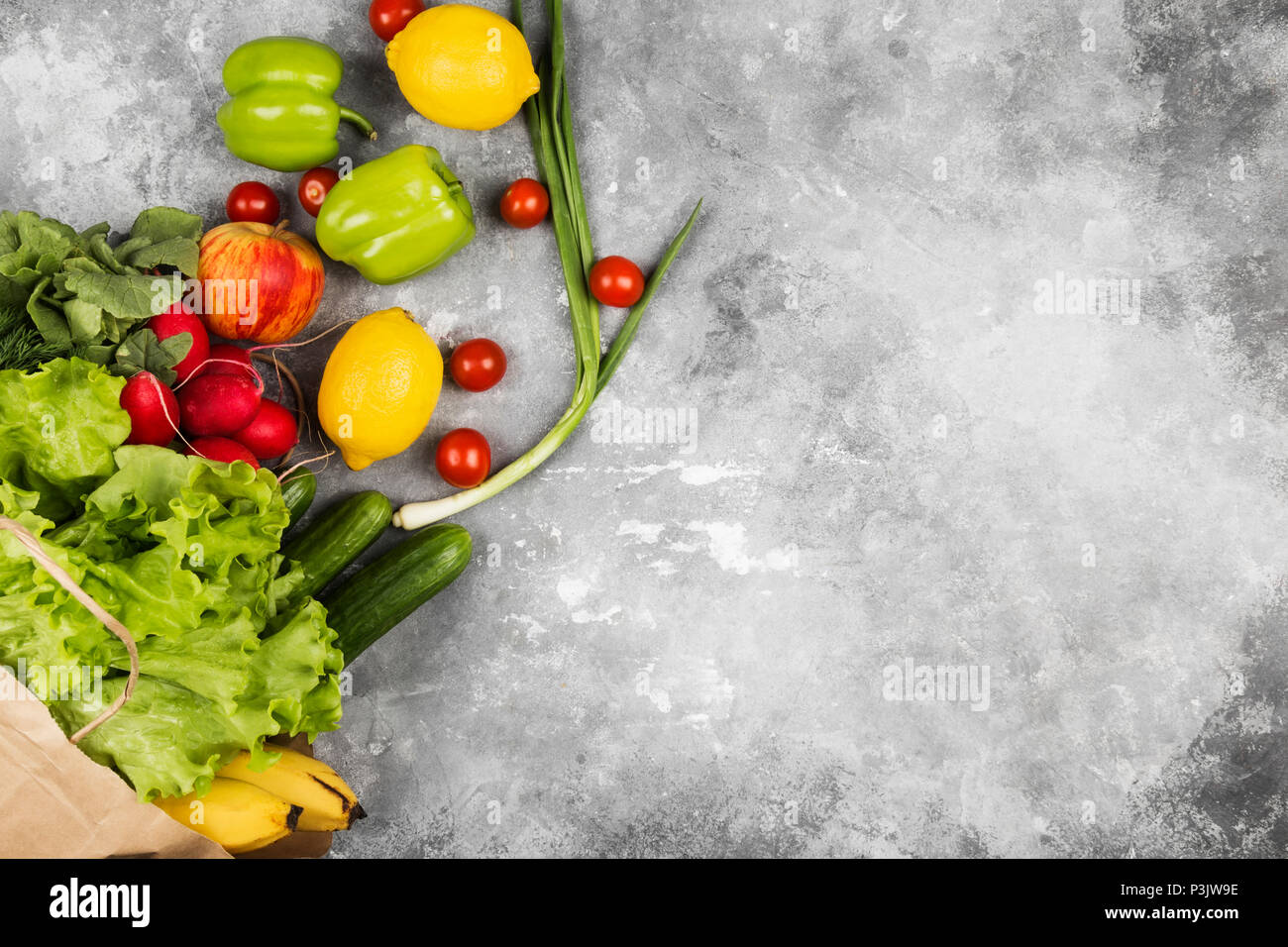 Various healthy food in paper bag on gray background. Top view, copy ...