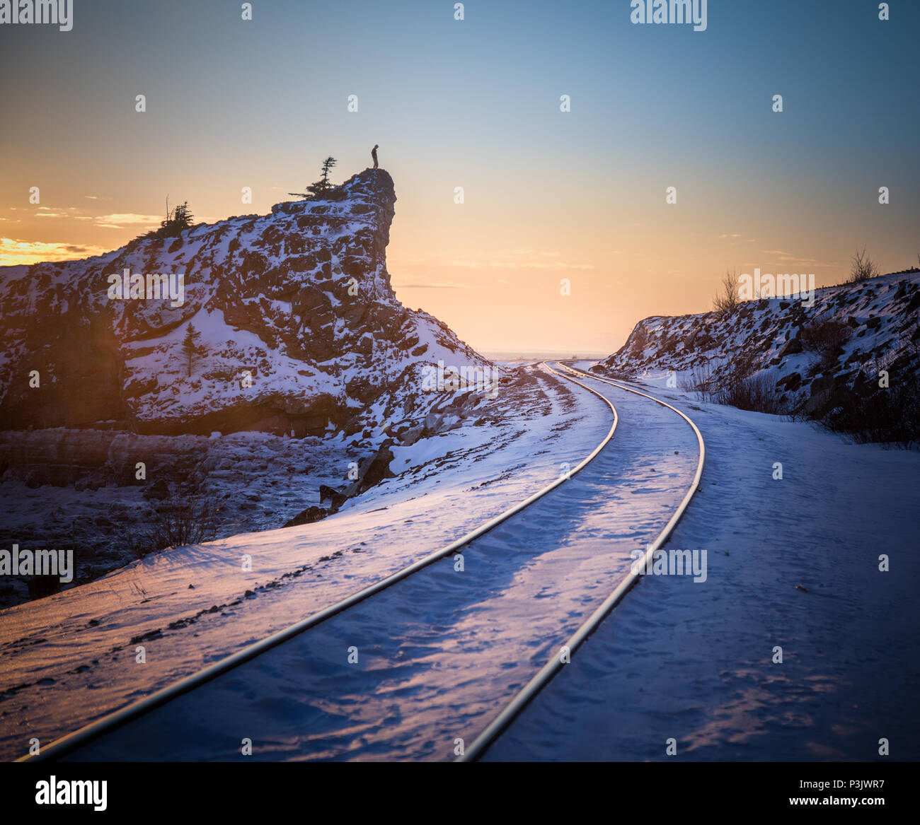 Man stands on top of the rock posing railroad railway train tracks ...