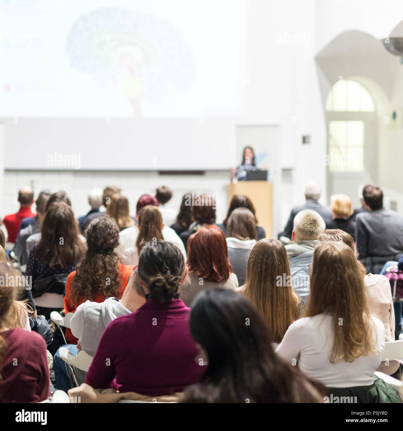 Woman giving presentation in lecture hall at university Stock Photo - Alamy