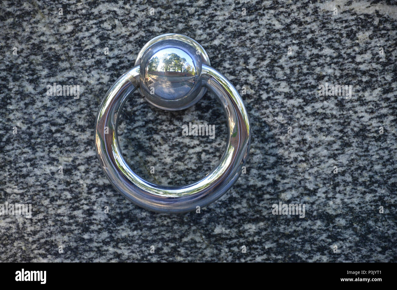 Metal ring on grave of cemetery. Rusty iron handle on granite tomb ...