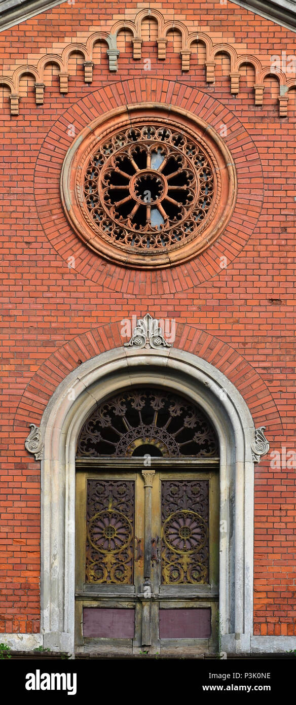 Texture front part of an ancient brick crypt with a round patterned ...