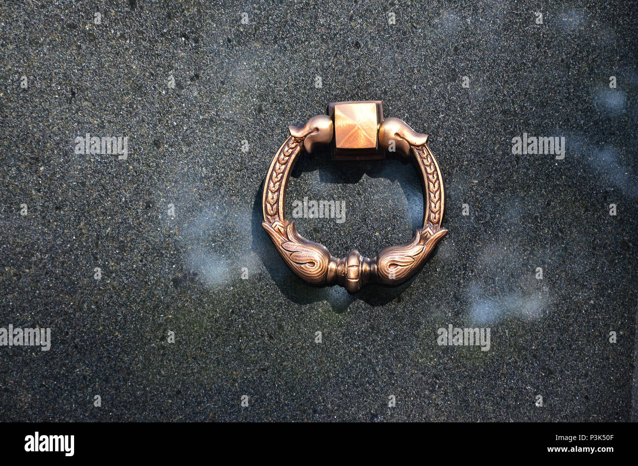 Metal ring on grave of cemetery. Rusty iron handle on granite tomb ...