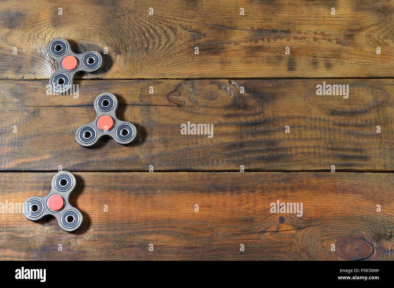 A rare handmade wooden fidget spinners lies on a brown wooden ...