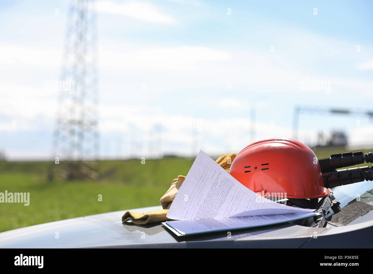 An electrician in the fields near the power transmission line. The ...