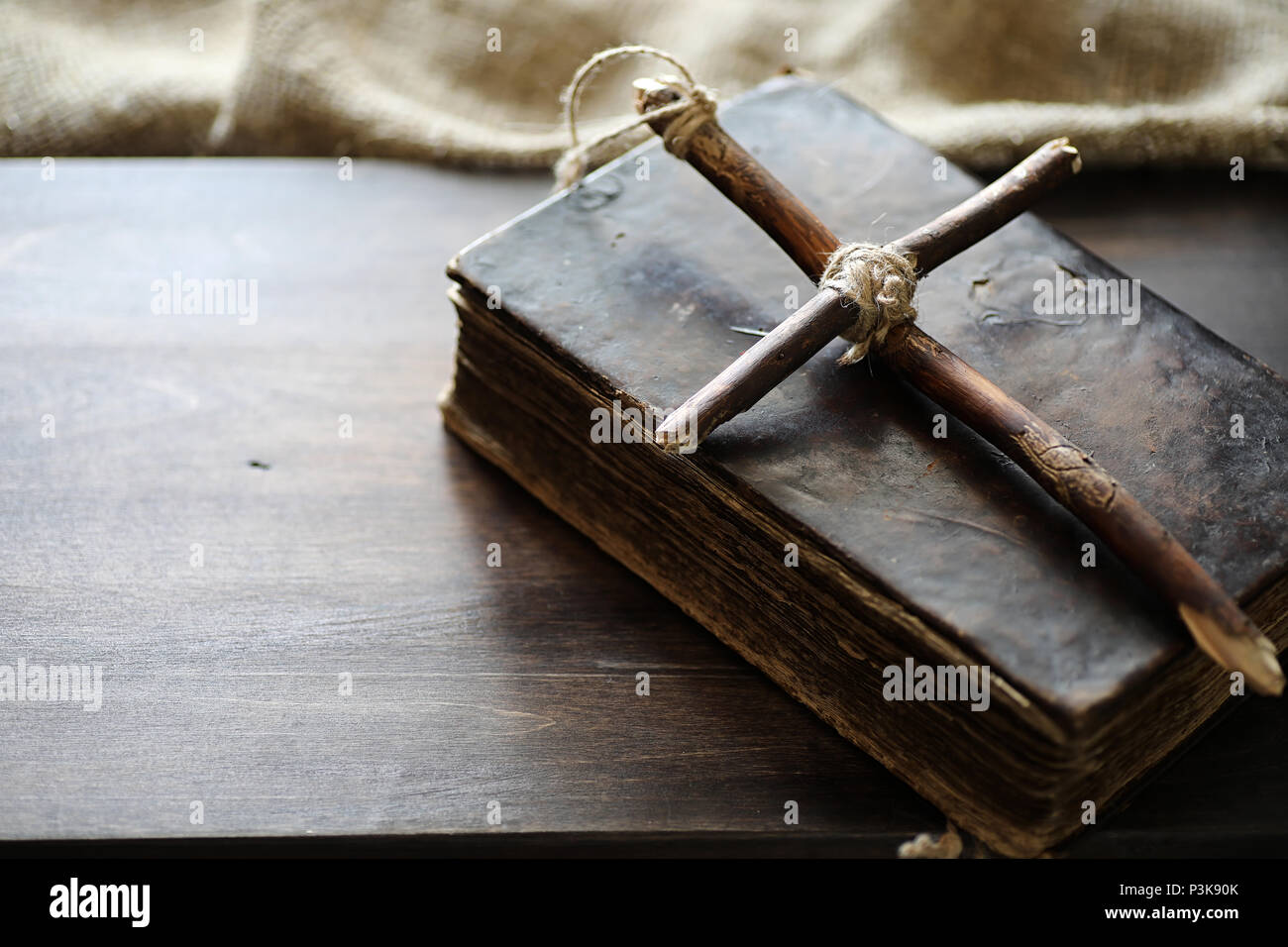 Ancient religious book and wooden cross on the background of a wooden ...