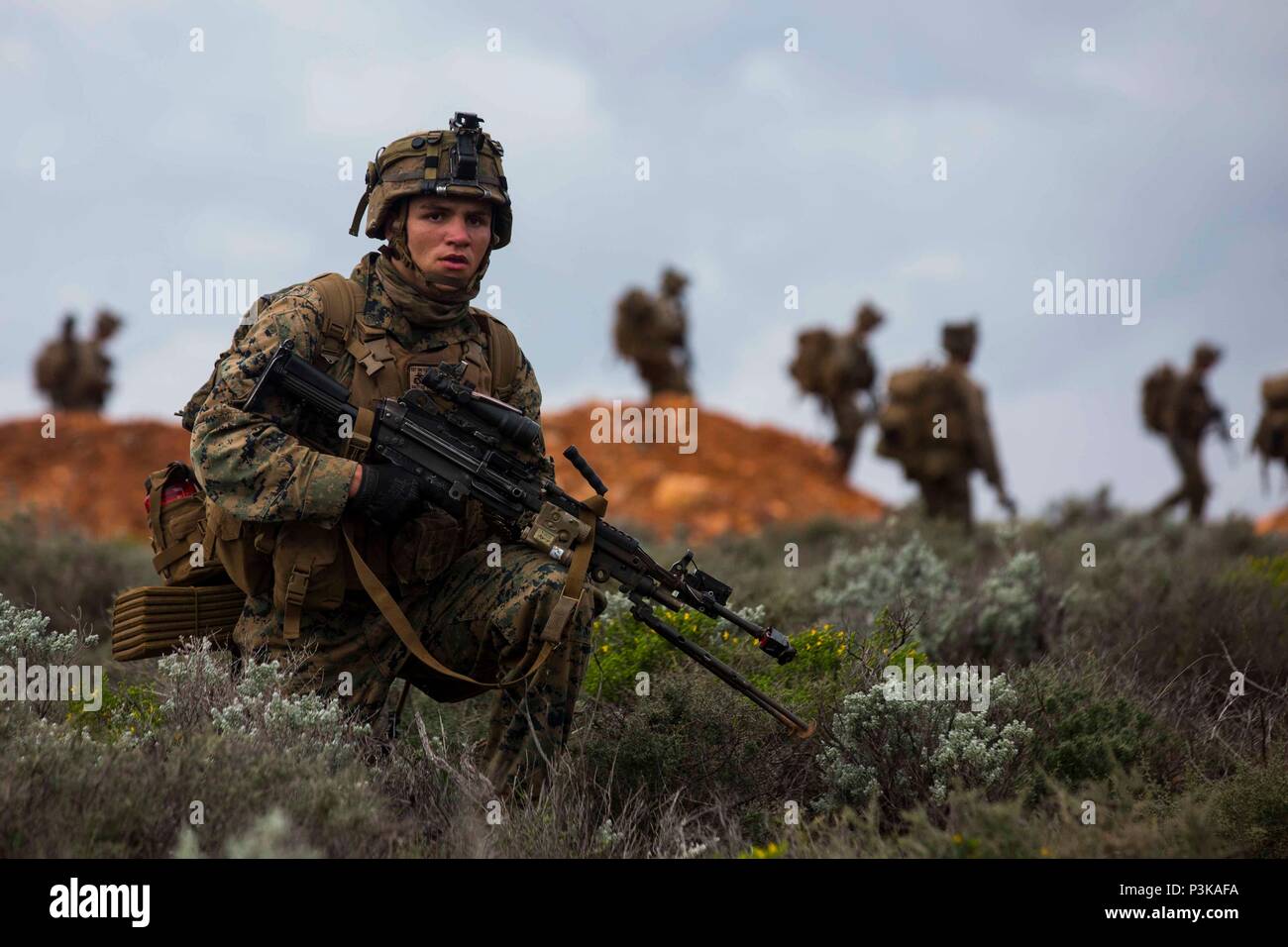 Lance Cpl. Eric J. Radtke, a rifleman, scans the area outside of their ...