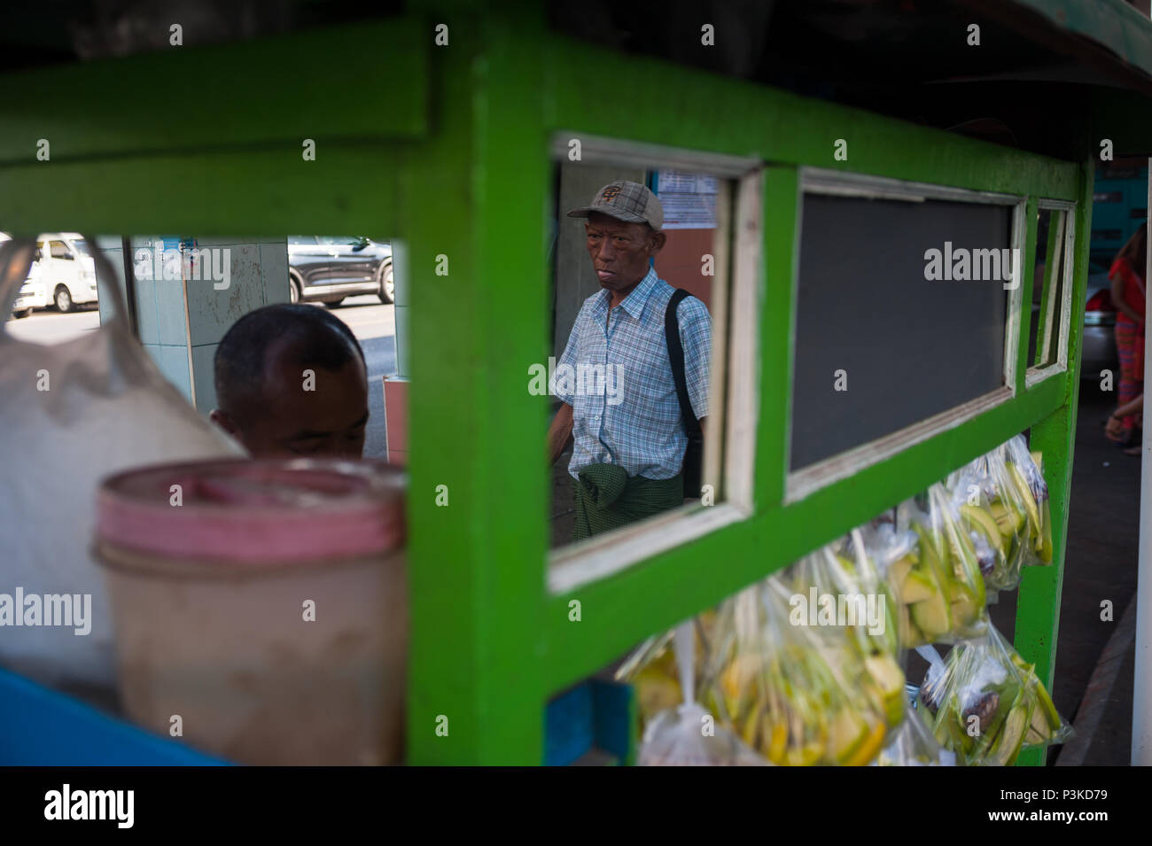 Yangon, Myanmar, reflection of a passerby Stock Photo - Alamy