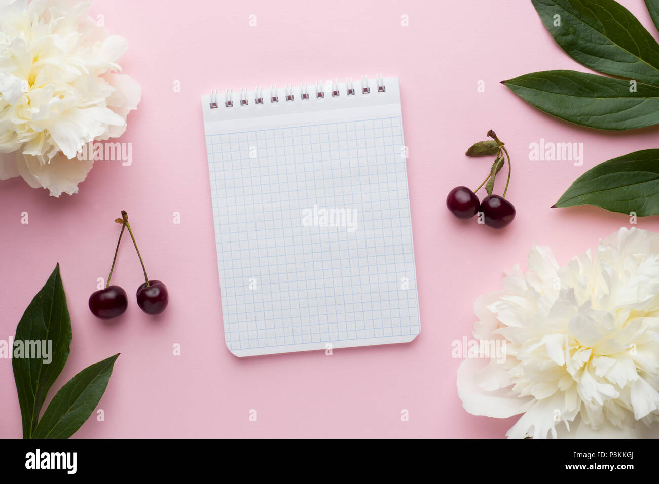 Notepad for text white flowers peony cherry berries on pastel pink ...