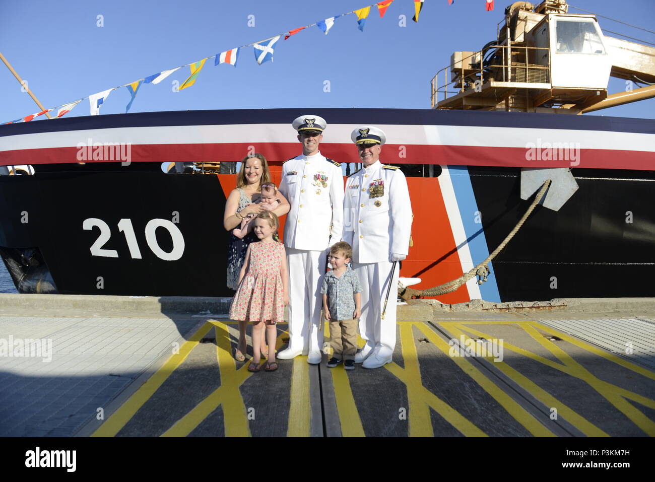 Rear Adm. Dave Callahan stands with Lt. Cmdr. Benjamin R. Keffer and ...