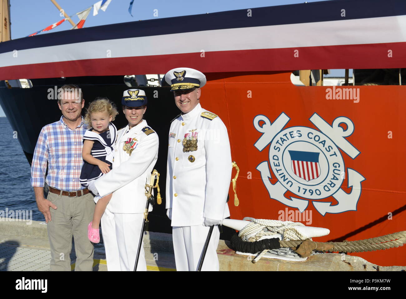 Rear Adm. Dave Callahan stands with Cmdr. Amy E. Florentino and her ...