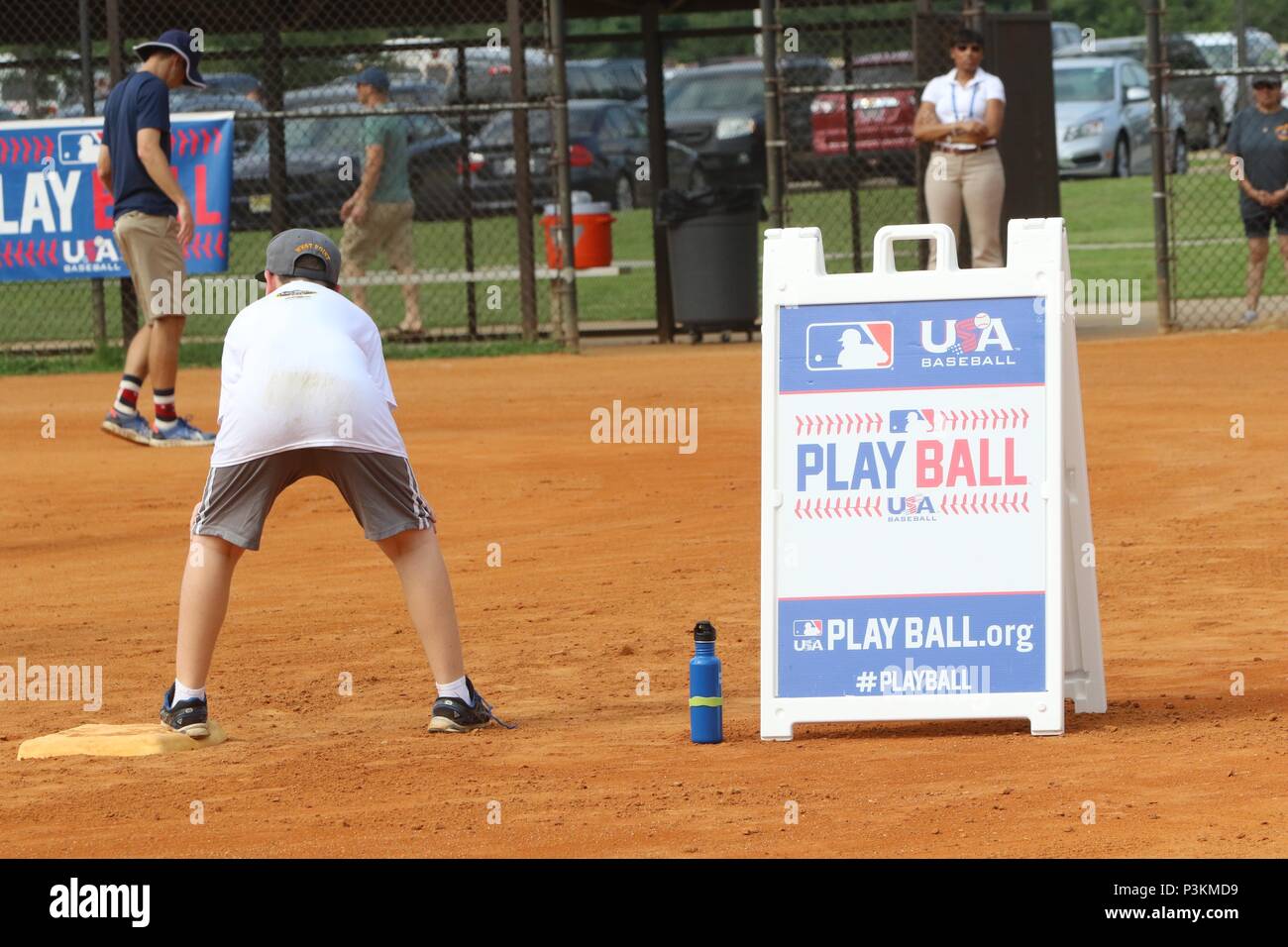 A young baseball prepares to run for home plate while participating in ...