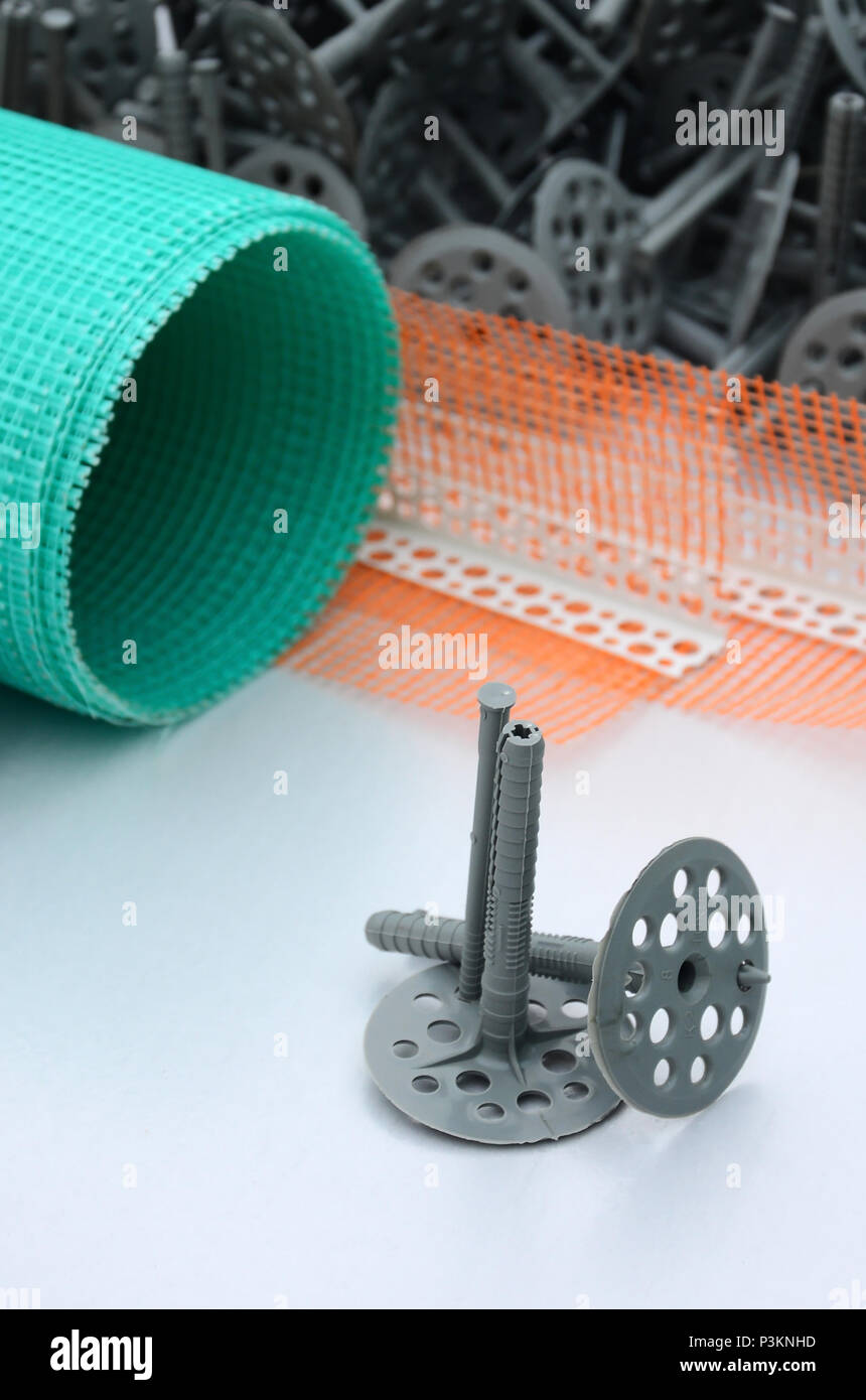 A set of construction items for the insulation of walls. Plastic dowels ...