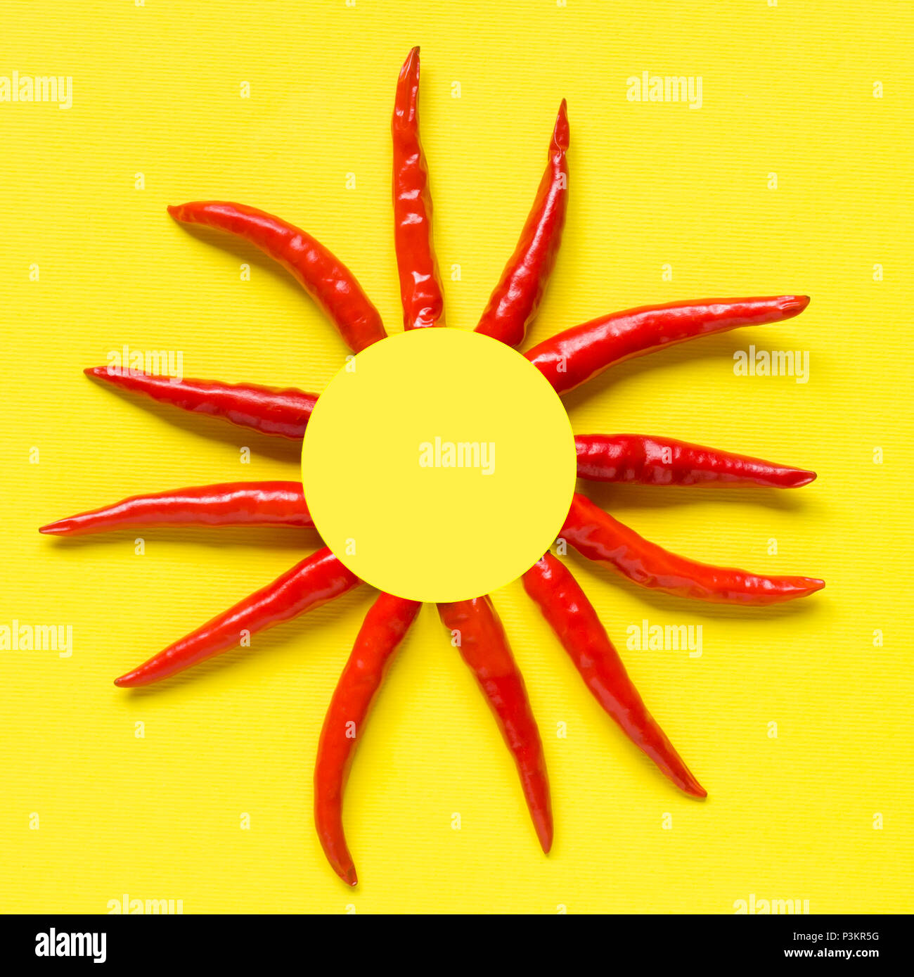 Red chili pepper pods on bright yellow background Stock Photo - Alamy