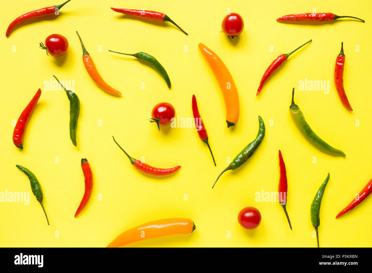 Assorted chili pepper tomato cherry On yellow bright background Stock ...