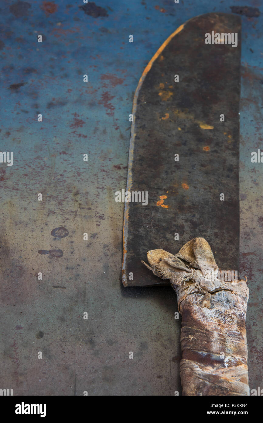 Vintage butcher cleaver on grunge rusty table, space for text or menu ...