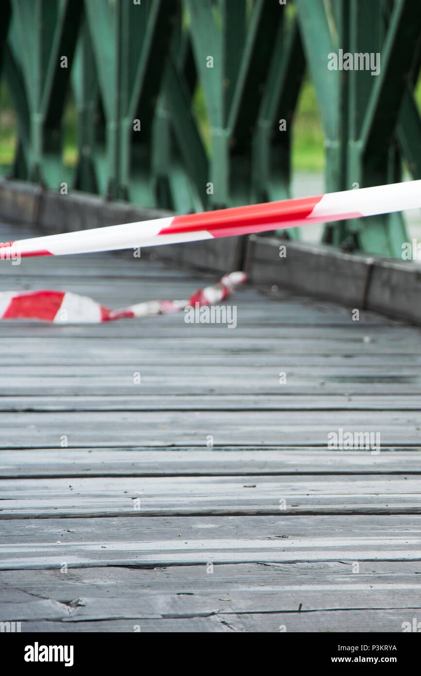 White and red warning line on the old bridge Stock Photo - Alamy