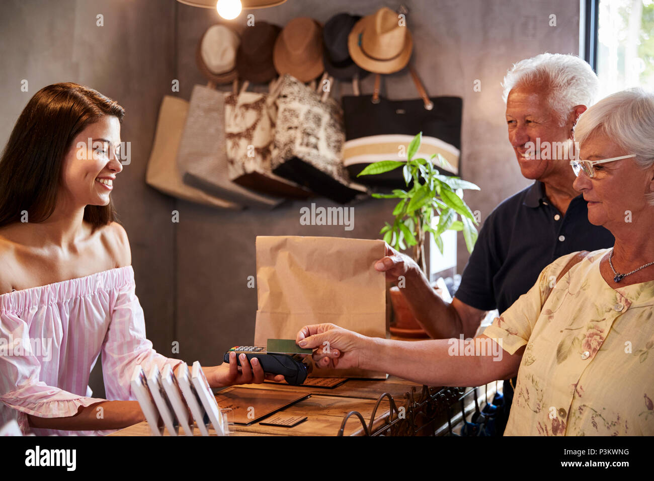 Senior Customers Buying Goods In Store Using Contactless Payment Stock ...