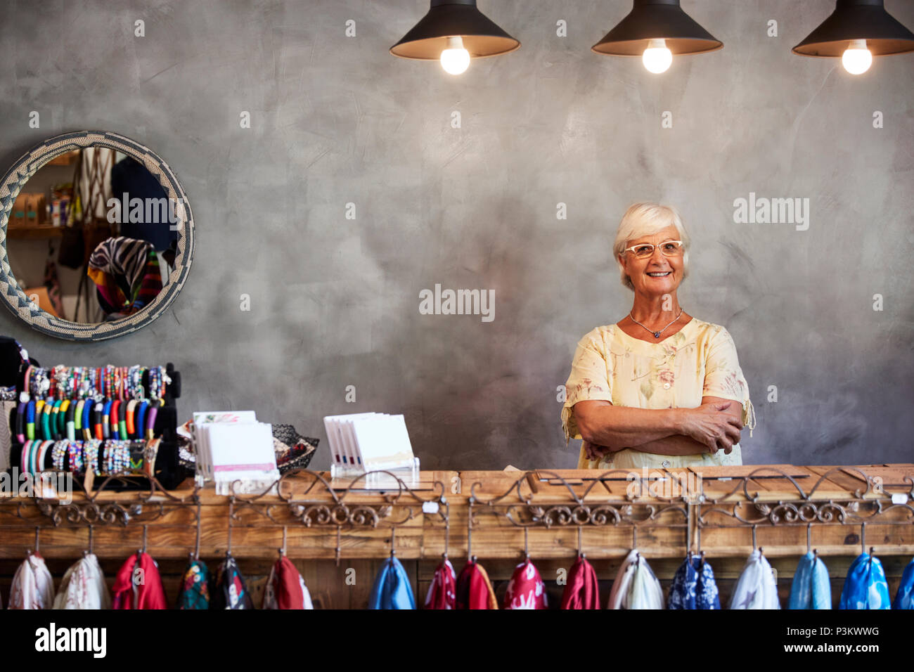Portrait Of Senior Female Store Owner Standing Behind Cash Desk Stock ...