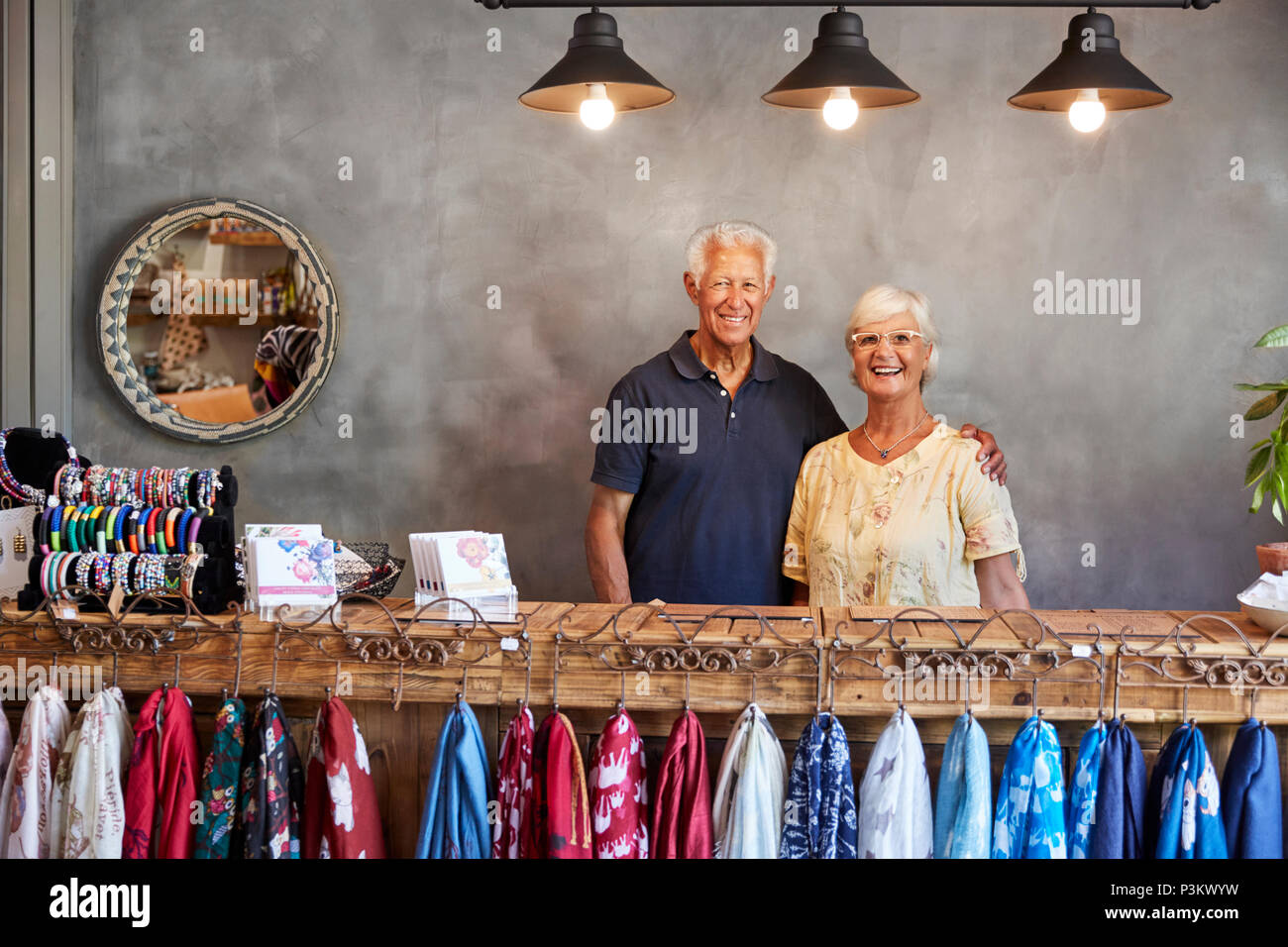 Portrait Of Senior Store Owners Standing Behind Cash Desk Stock Photo ...