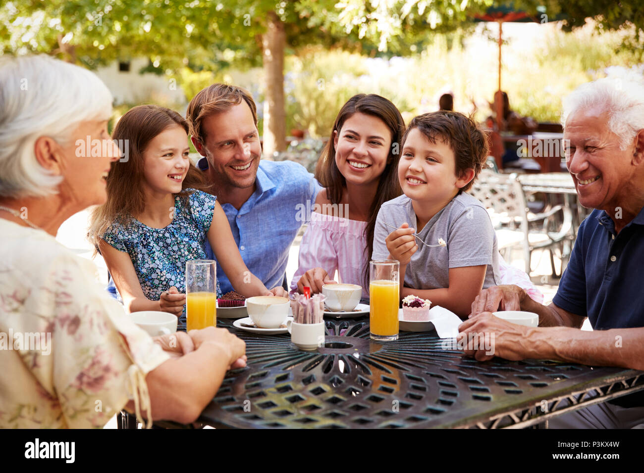 Multi Generation Family Enjoying Snack At Outdoor Café Together Stock ...
