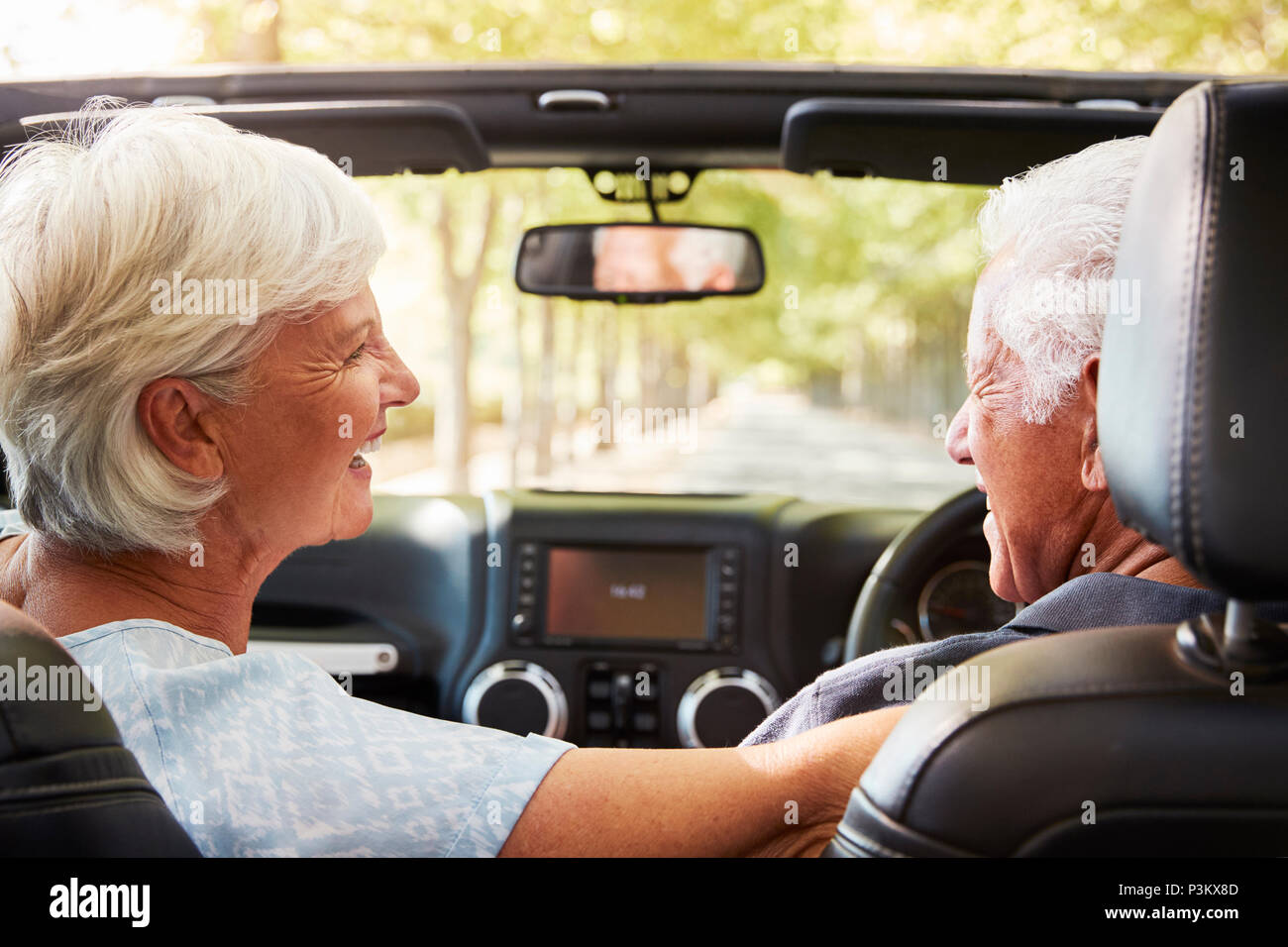 Senior Couple Drive Open Top Car On Countryside Road Trip Stock Photo ...