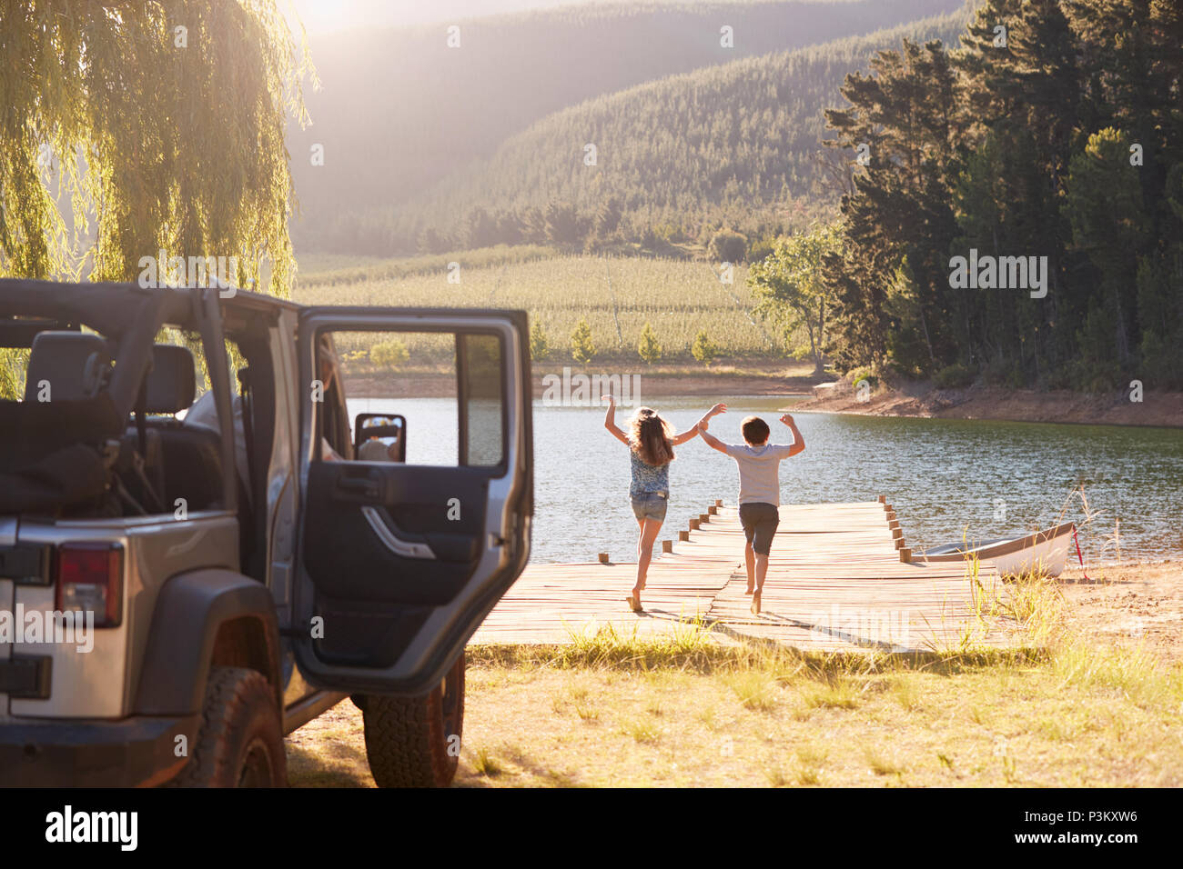 Family Reaching Destination By Lake After Road Trip Stock Photo - Alamy